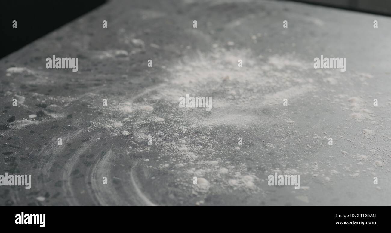 sprinkles flour on countertop surface, wide photo Stock Photo - Alamy