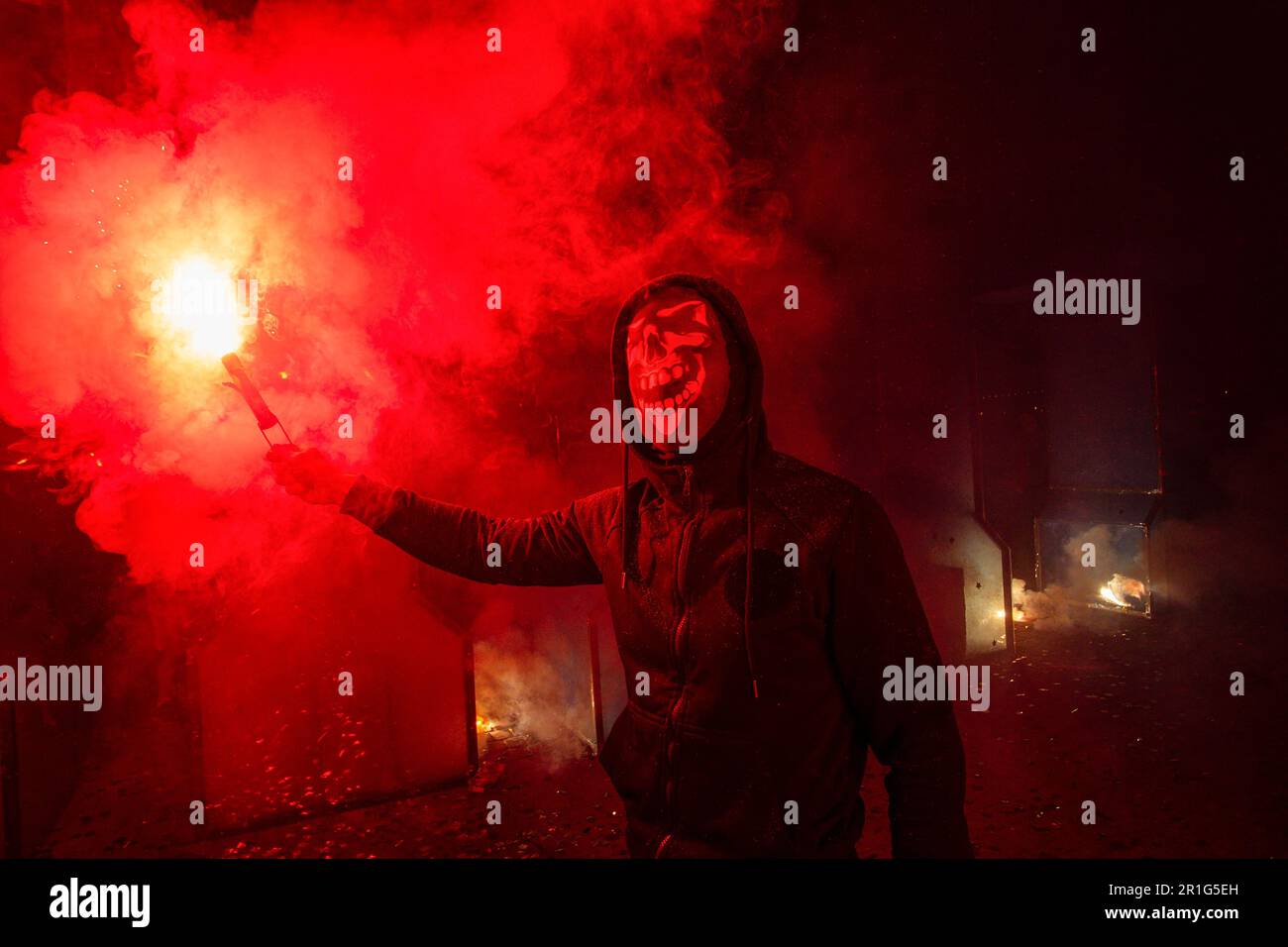 A football fan with a fire flare in his hands during a football parade ...