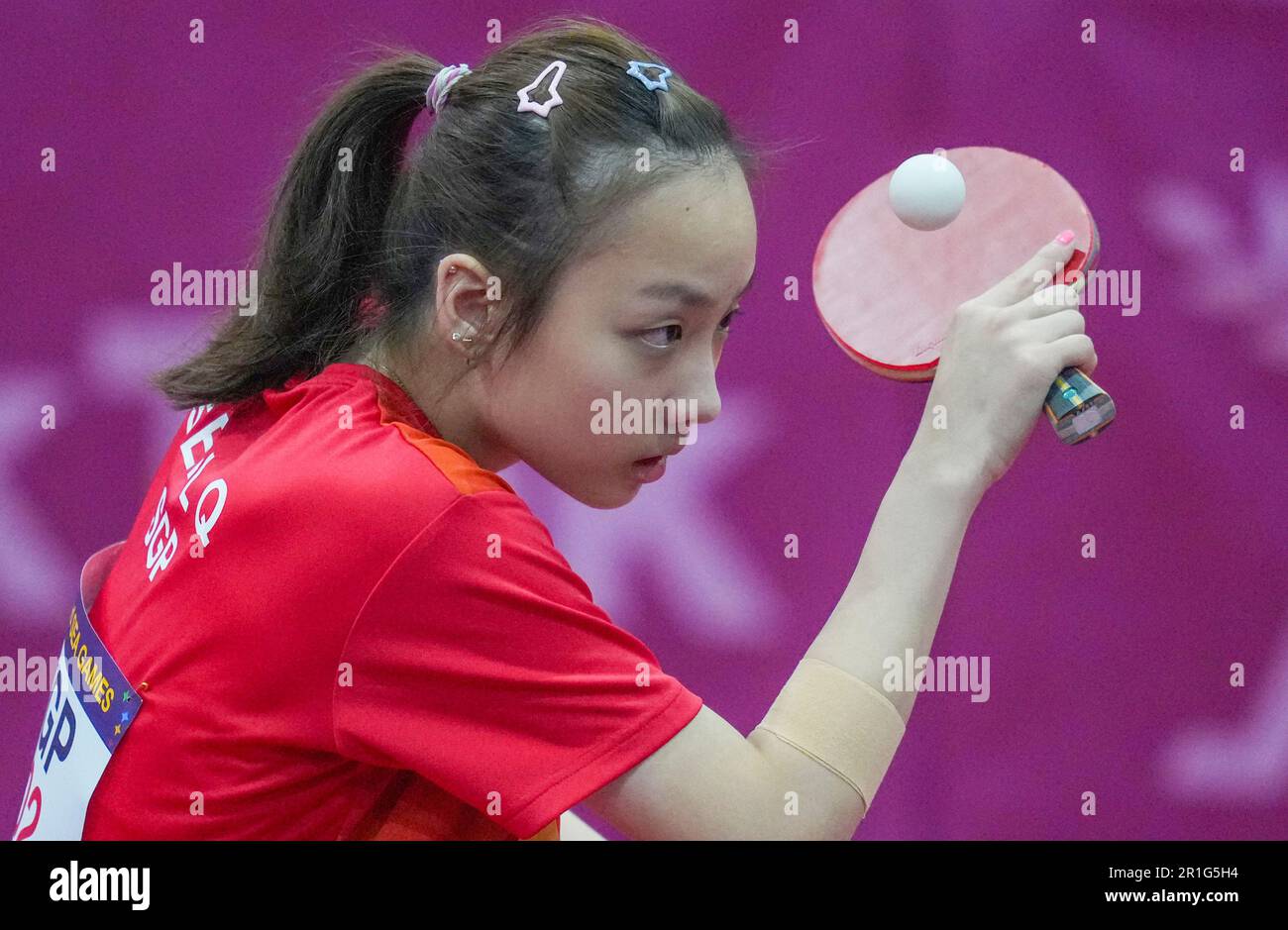 Singapore's Lin Qian Ser keeps her eyes on the ball against Thailand's ...
