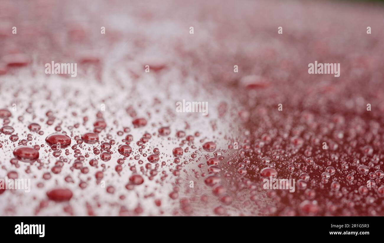 water beading on red car with hydrophobic coating, wide photo Stock ...