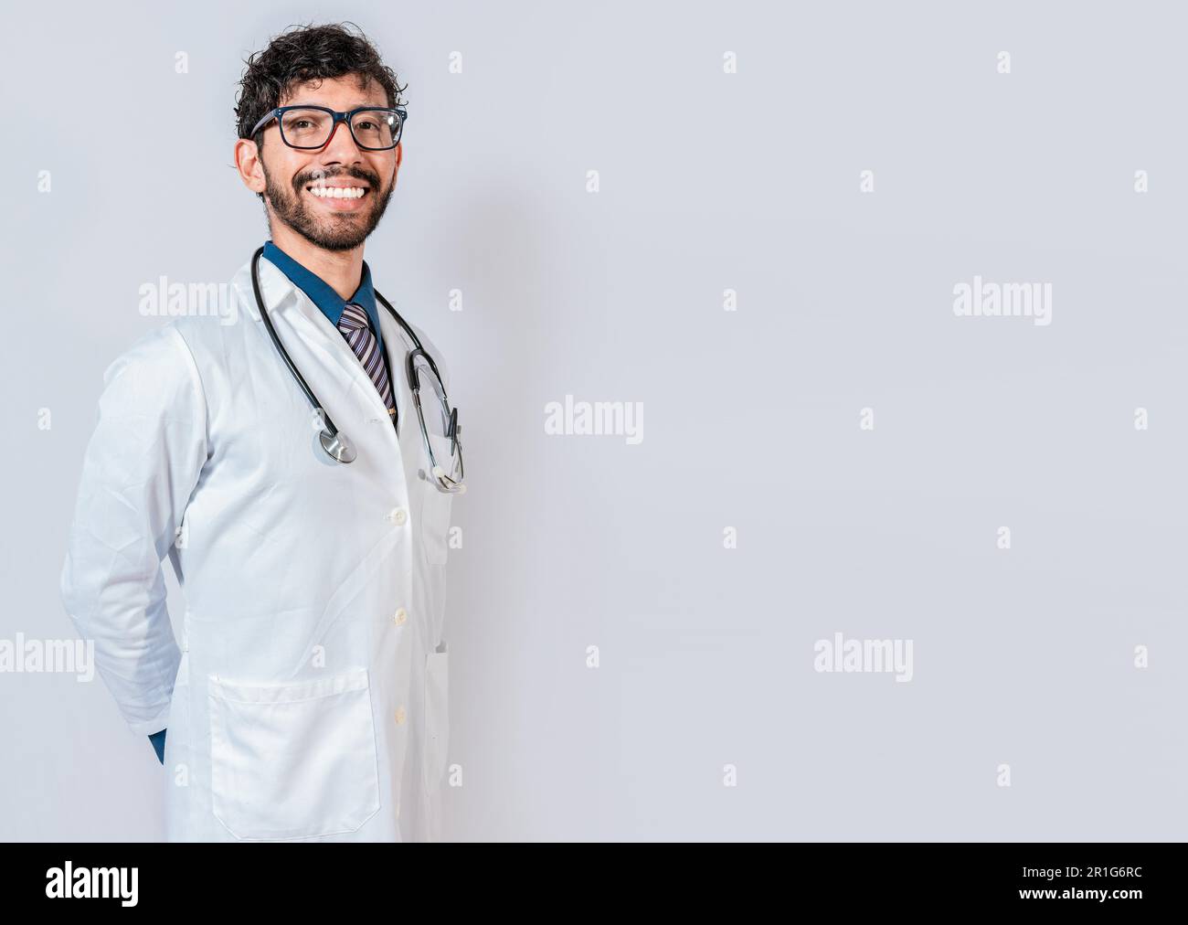 Portrait of happy doctor on isolated background. Happy latin doctor ...
