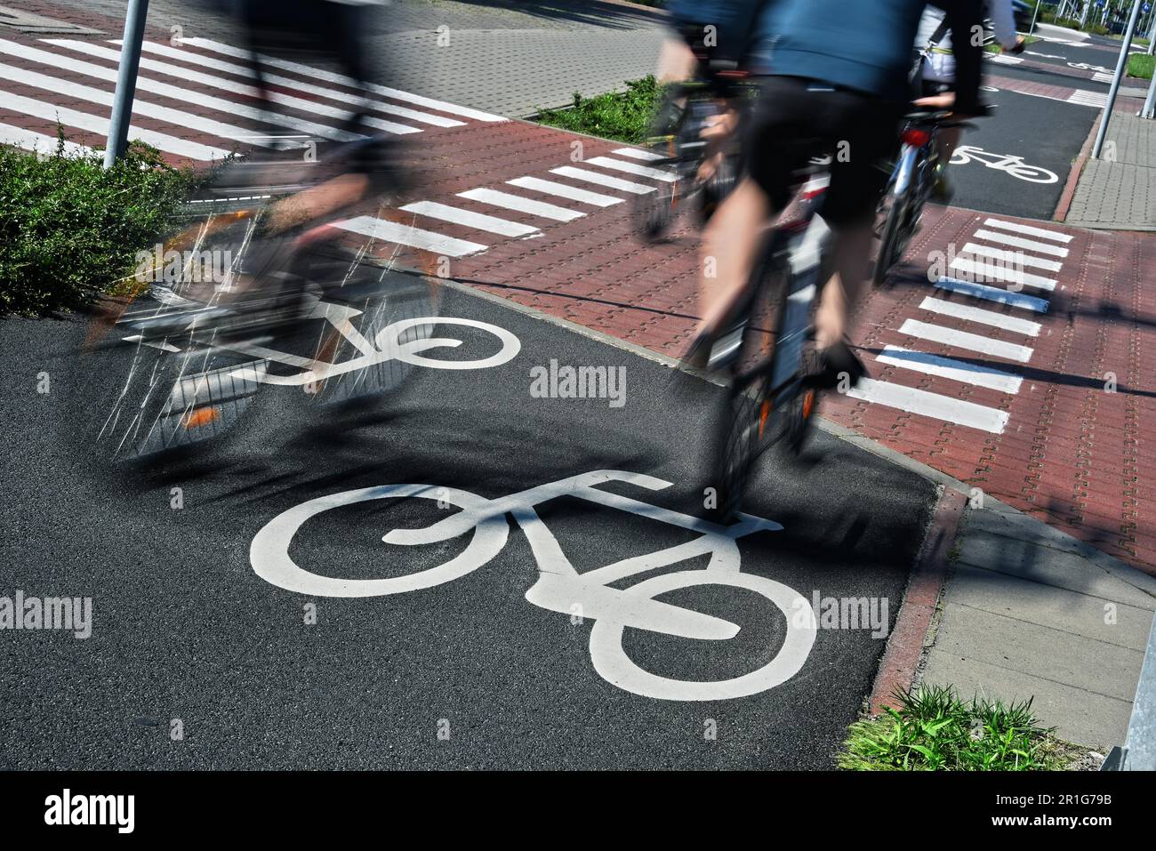 Bicycle road sign and bike riders Stock Photo - Alamy