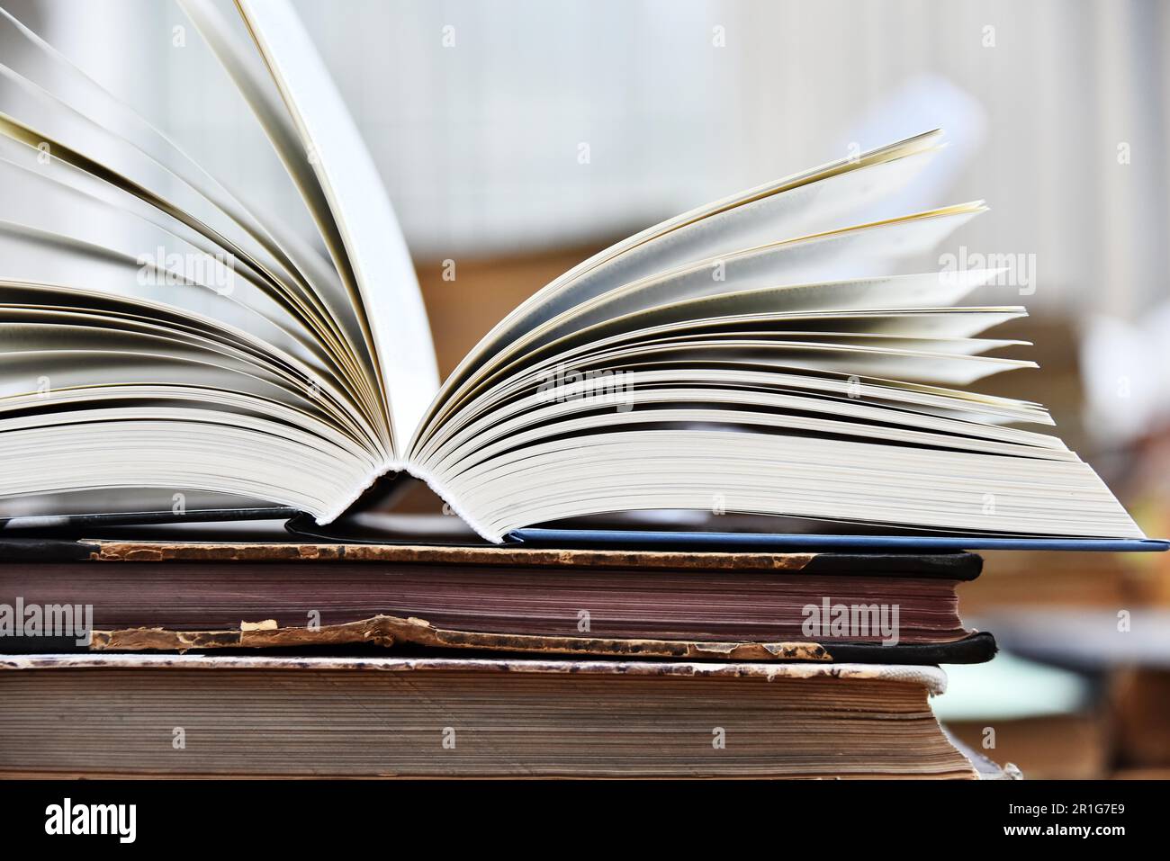 Hardcover book lying on the table in a library Stock Photo - Alamy