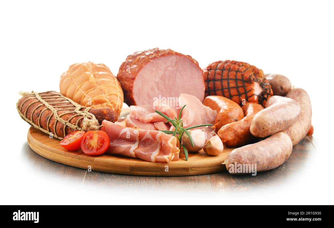 Assorted meat products including ham and sausages isolated on white ...