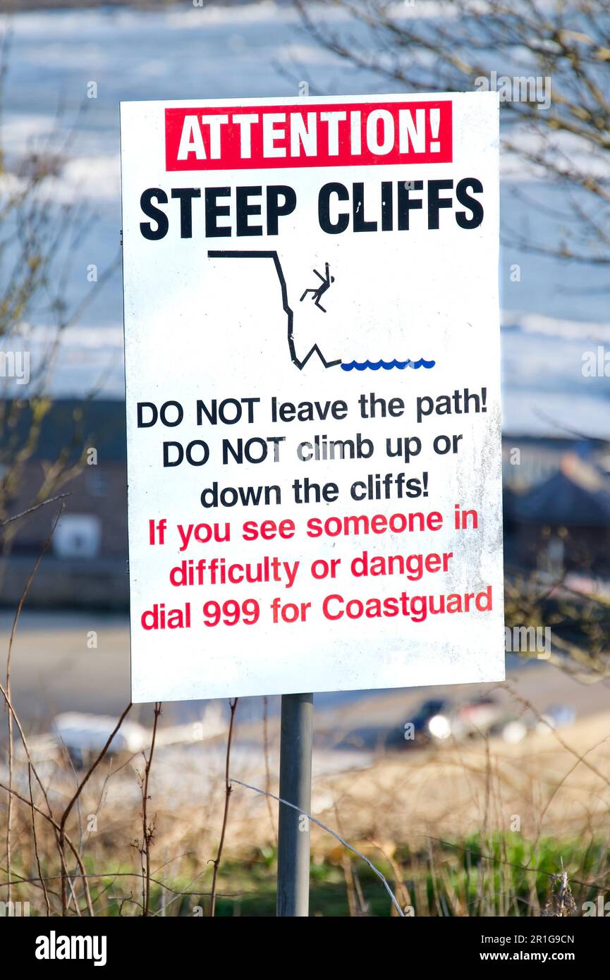 Steep cliffs warning sign for tourists high above Stonehaven harbour ...