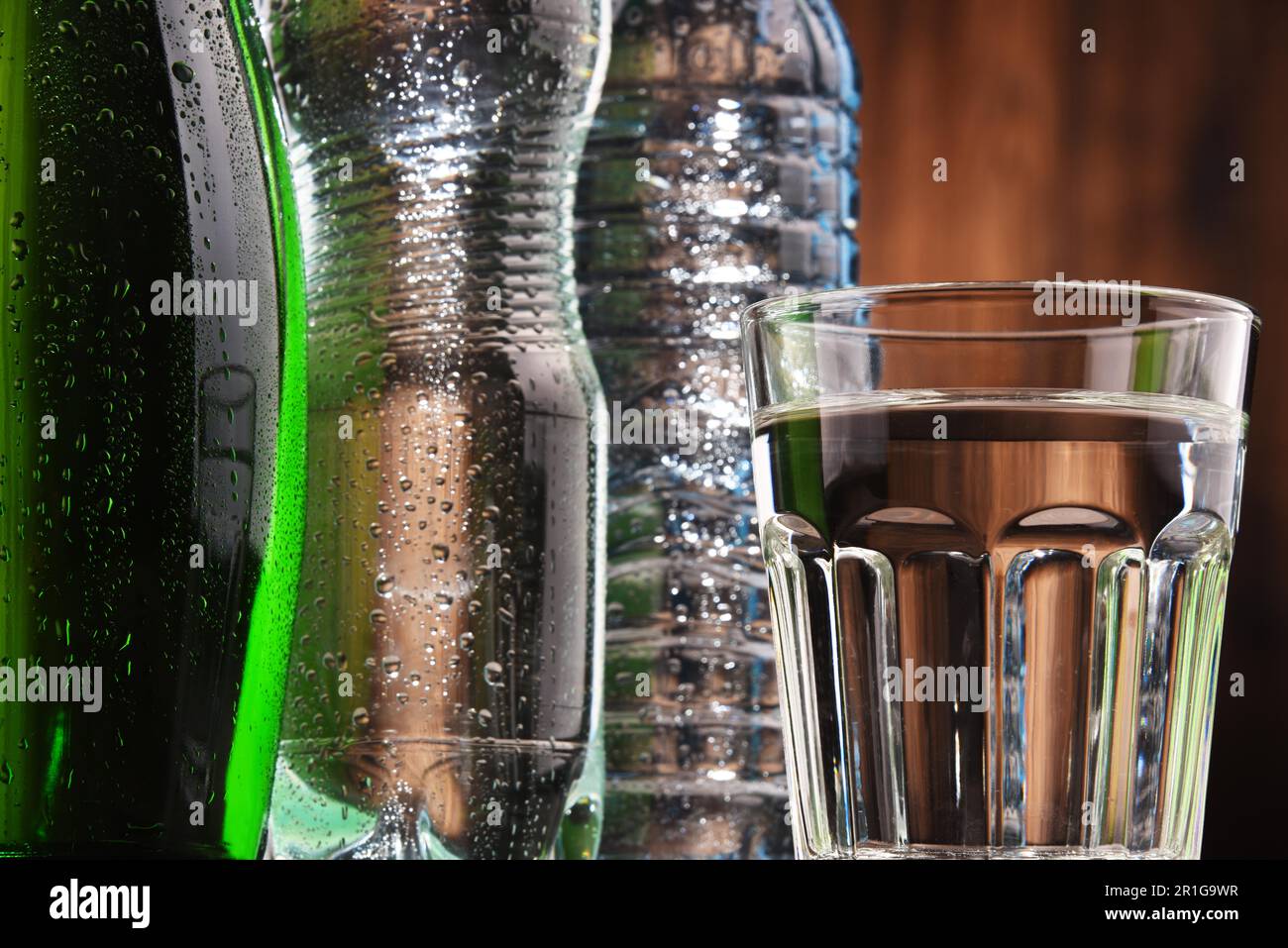 Composition with glass and bottles of mineral water Stock Photo - Alamy