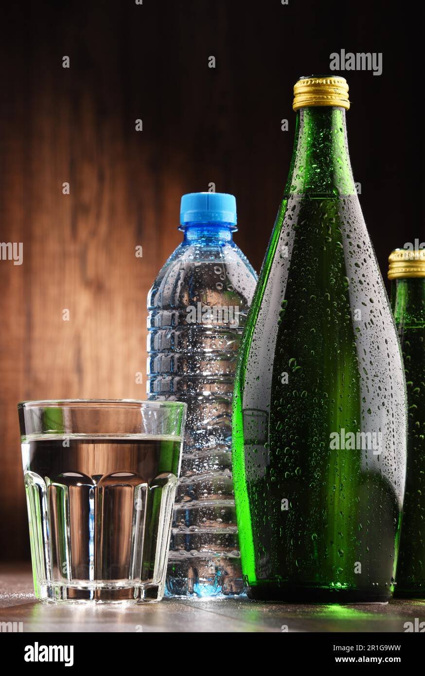 Composition with glass and bottles of mineral water Stock Photo - Alamy