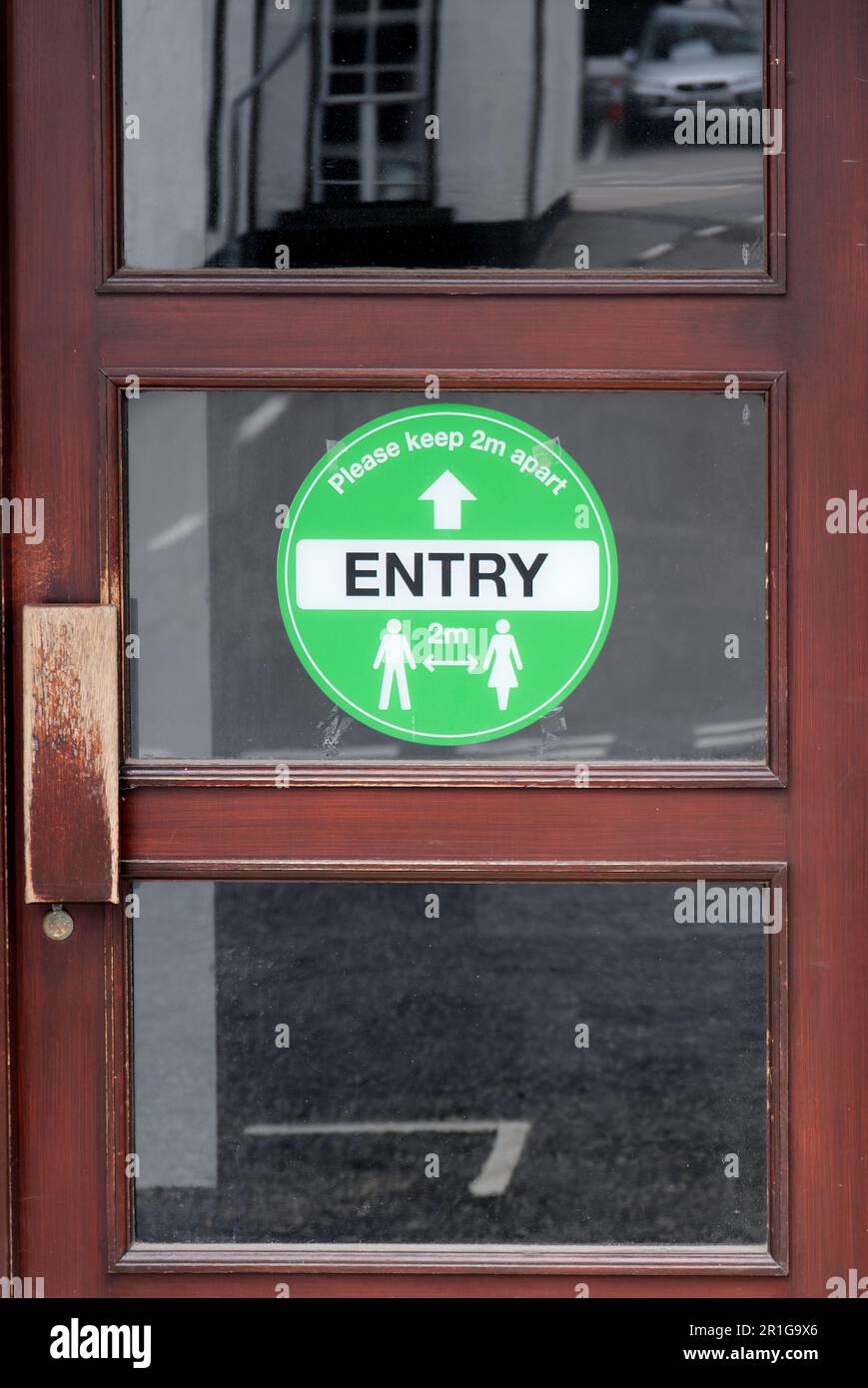 Entry sight on shop door for customer segregation Stock Photo - Alamy