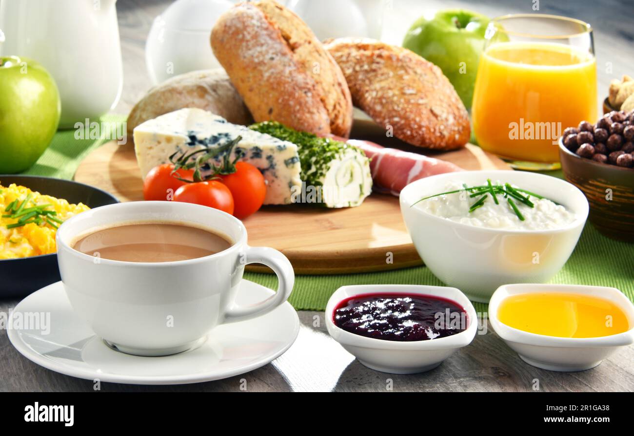 Breakfast served with coffee, orange juice, cheese, cereals and ...