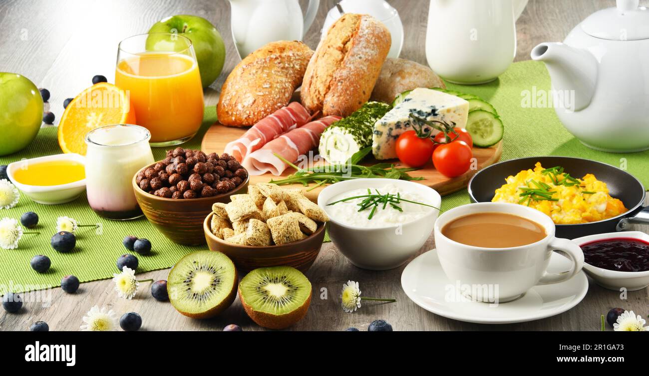 Breakfast served with coffee, orange juice, cheese, cereals and ...