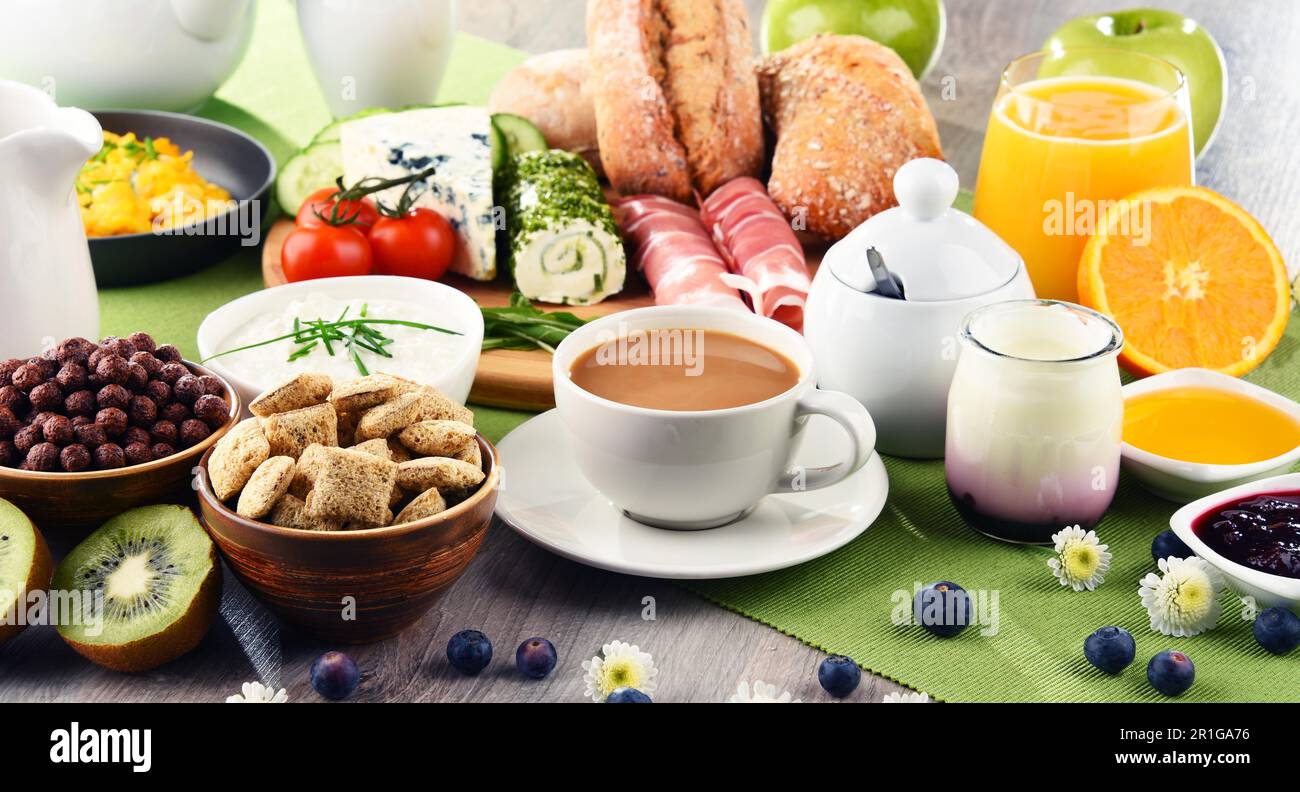 Breakfast served with coffee, orange juice, cheese, cereals and ...