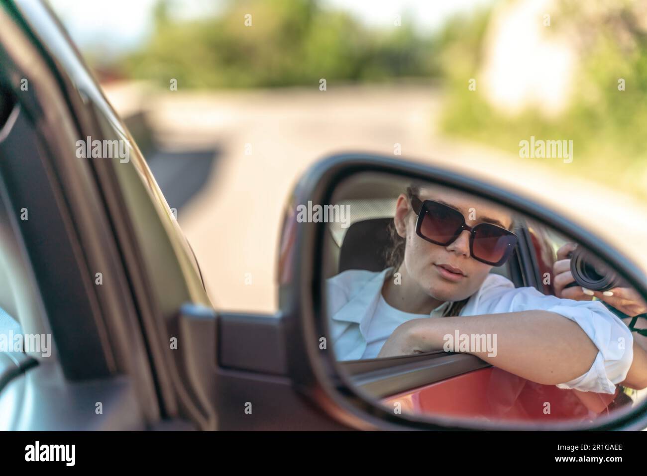 Woman car mirror. Portrait of a beautiful woman in a new car loo Stock ...