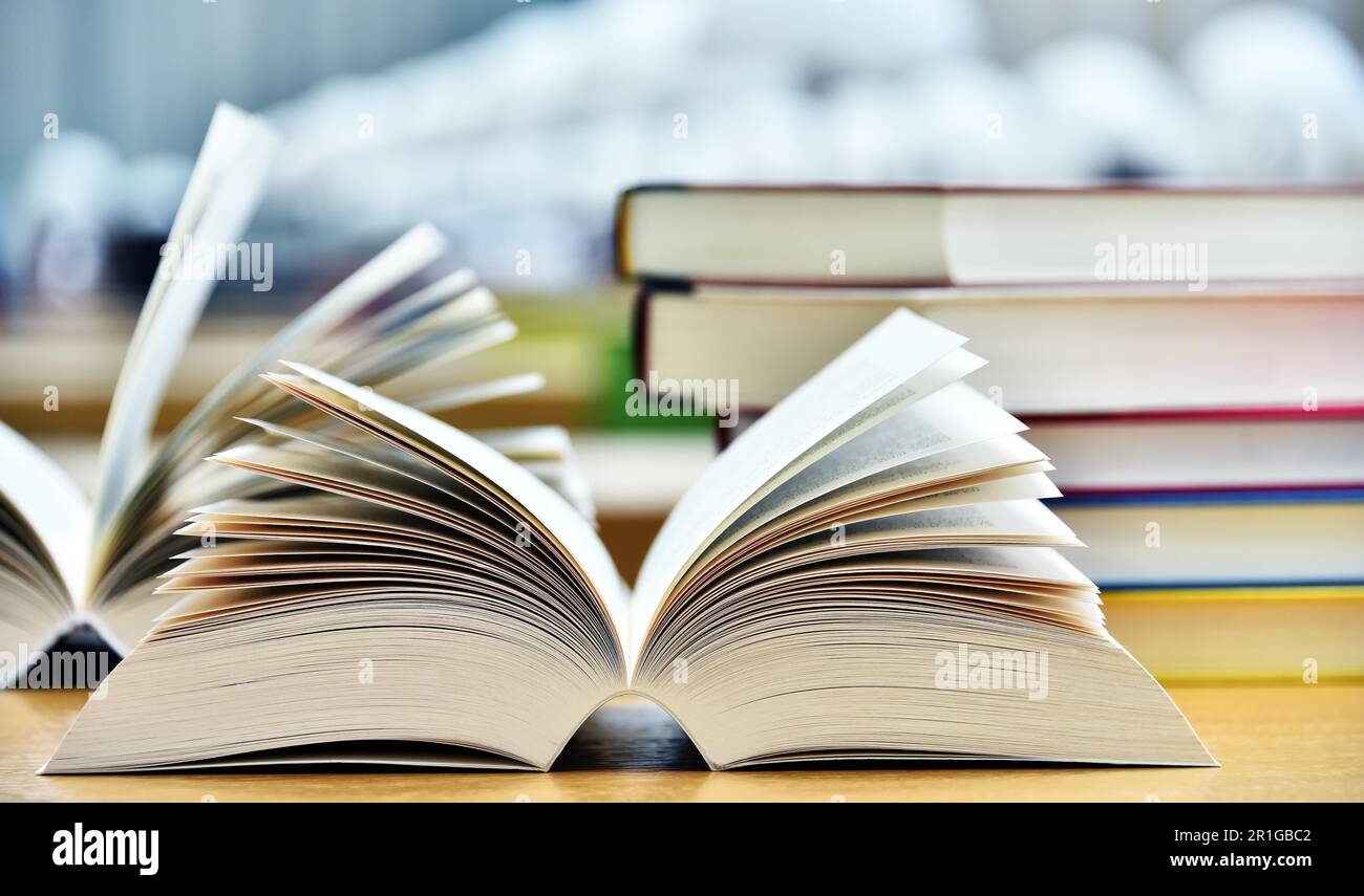 Books lying on the table in the public library Stock Photo - Alamy
