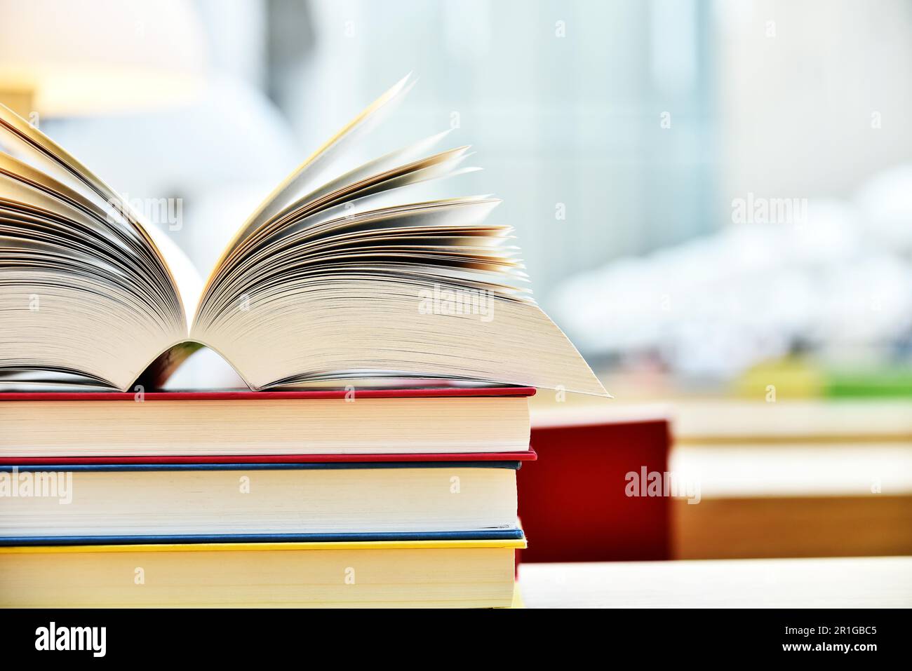 Books lying on the table in the public library Stock Photo - Alamy