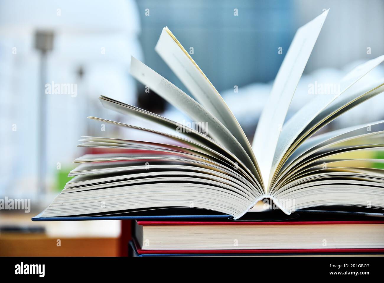 Books lying on the table in the public library Stock Photo - Alamy