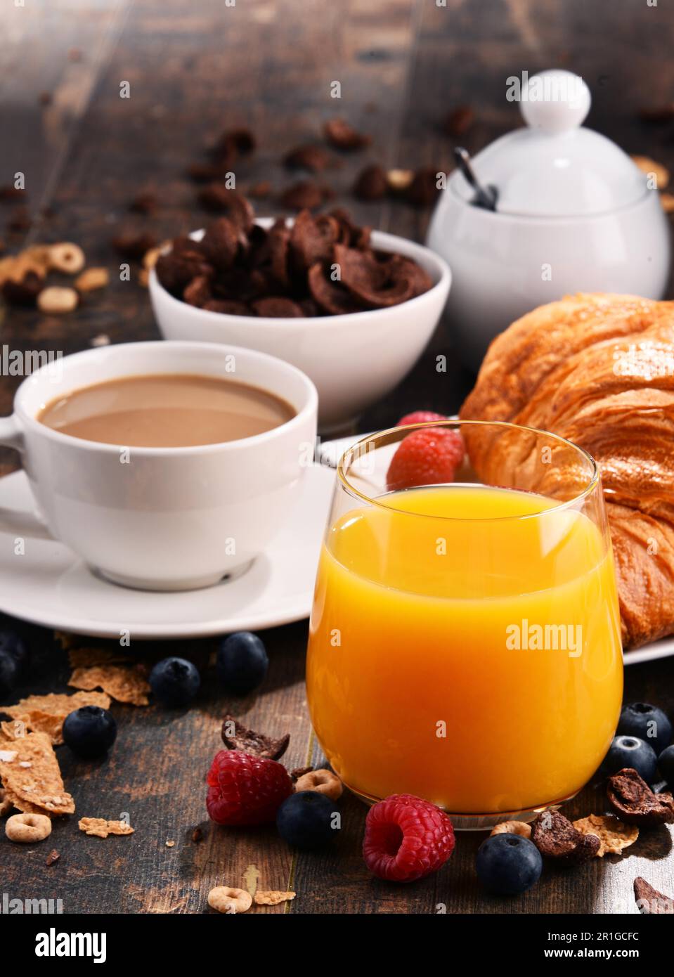 Breakfast served with coffee, orange juice, croissants, cereals and ...