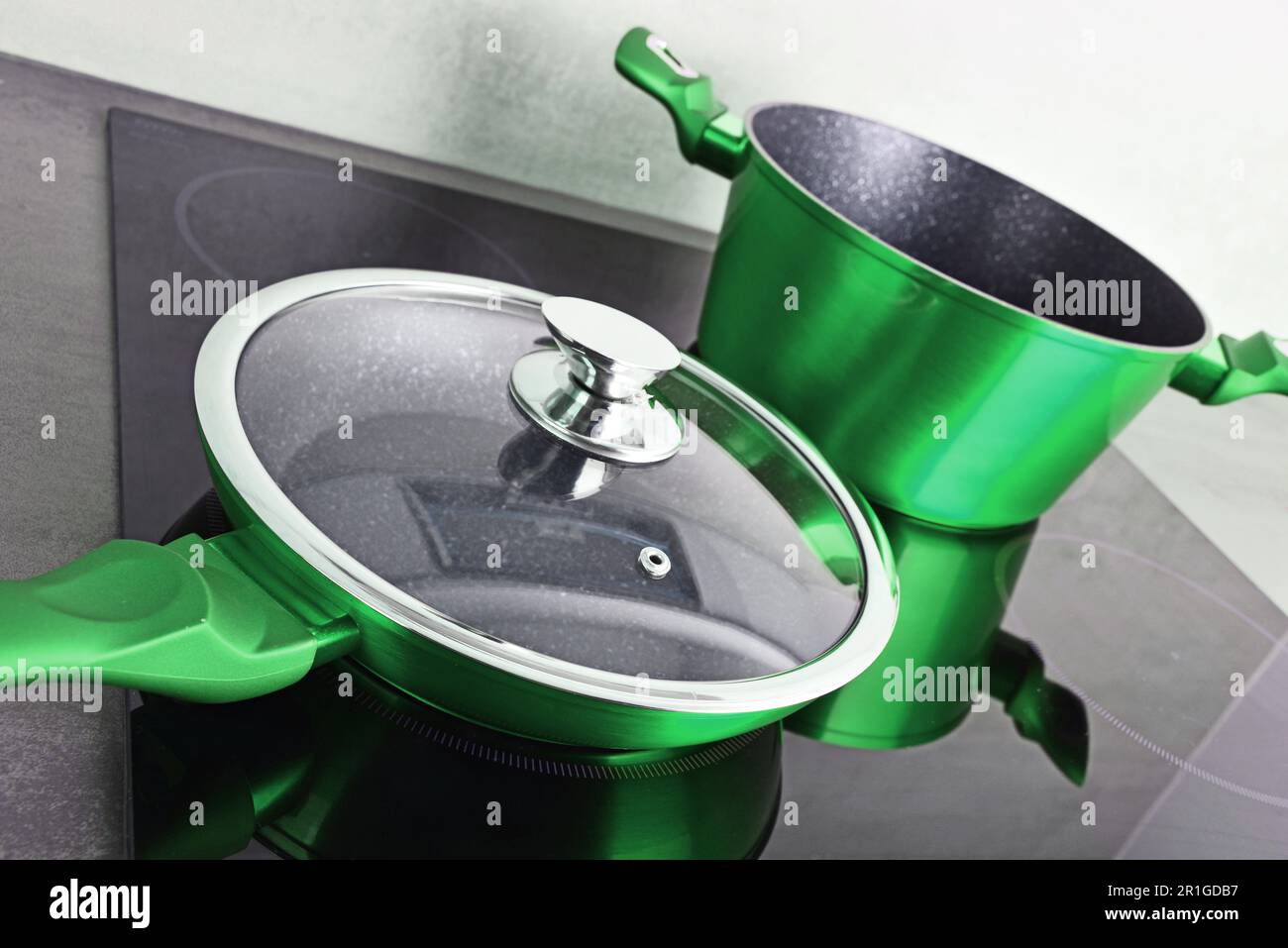 Frying pan and steel pot on modern induction cooktop Stock Photo - Alamy
