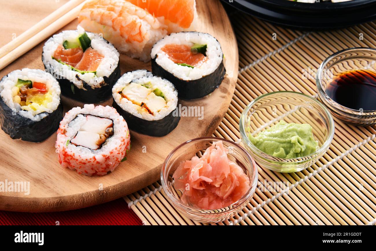 Composition with assorted sushi rolls and bowls of spices Stock Photo ...