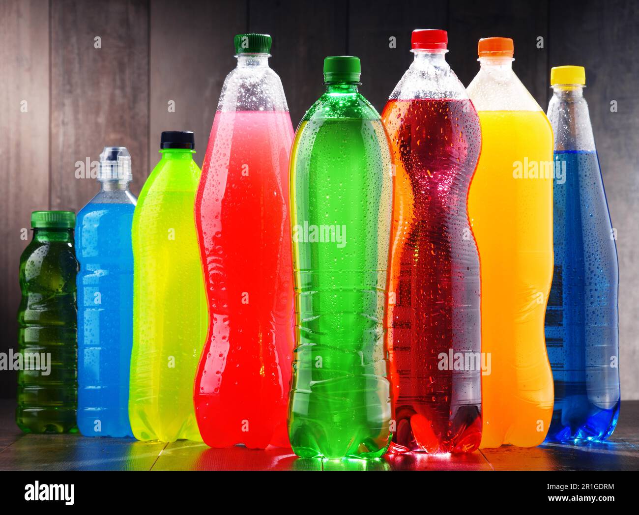 Plastic bottles of assorted carbonated soft drinks in variety of colors ...