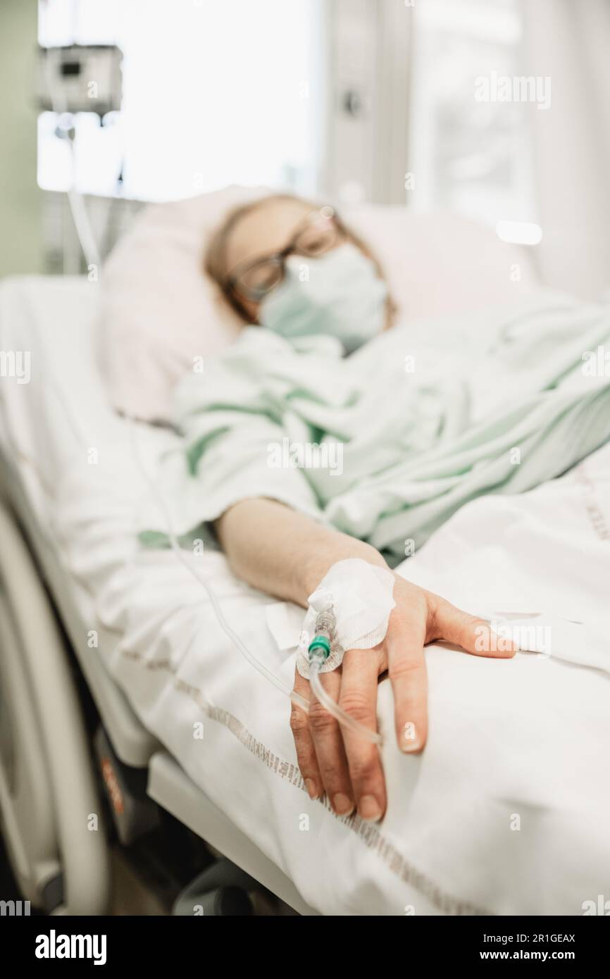 Focus on the woman hand of a patient with medical drip or IV drip in ...