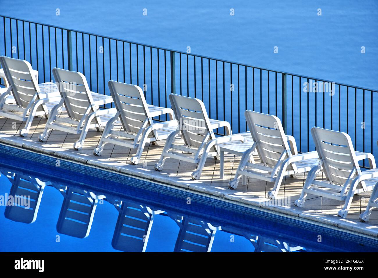 Row of free sunbeds at the swimming pool in a touristic resort Stock ...