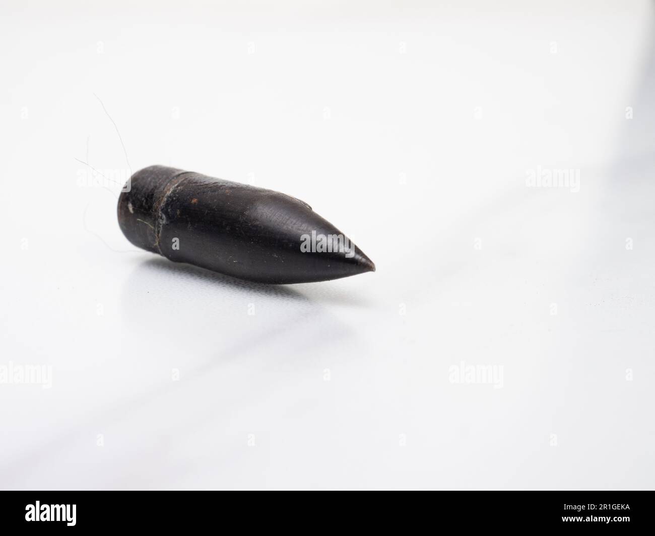 Picture of a sharp point black projectile on a white background Stock ...