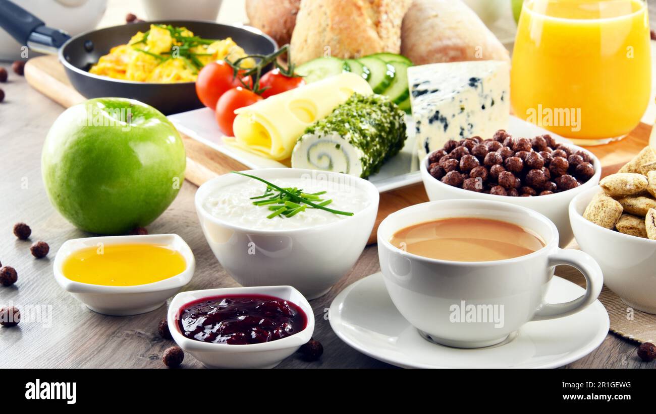 Breakfast served with coffee, orange juice, cheese, cereals and ...