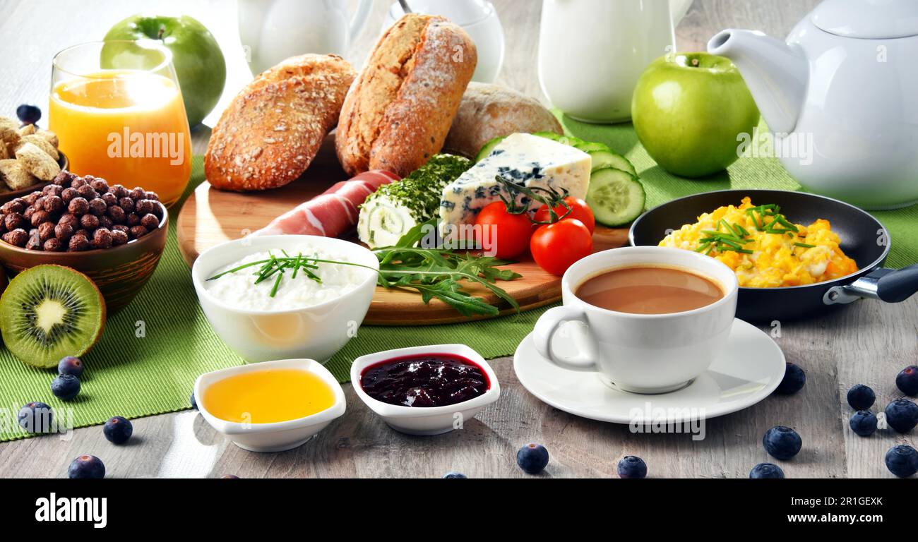 Breakfast served with coffee, orange juice, cheese, cereals and ...