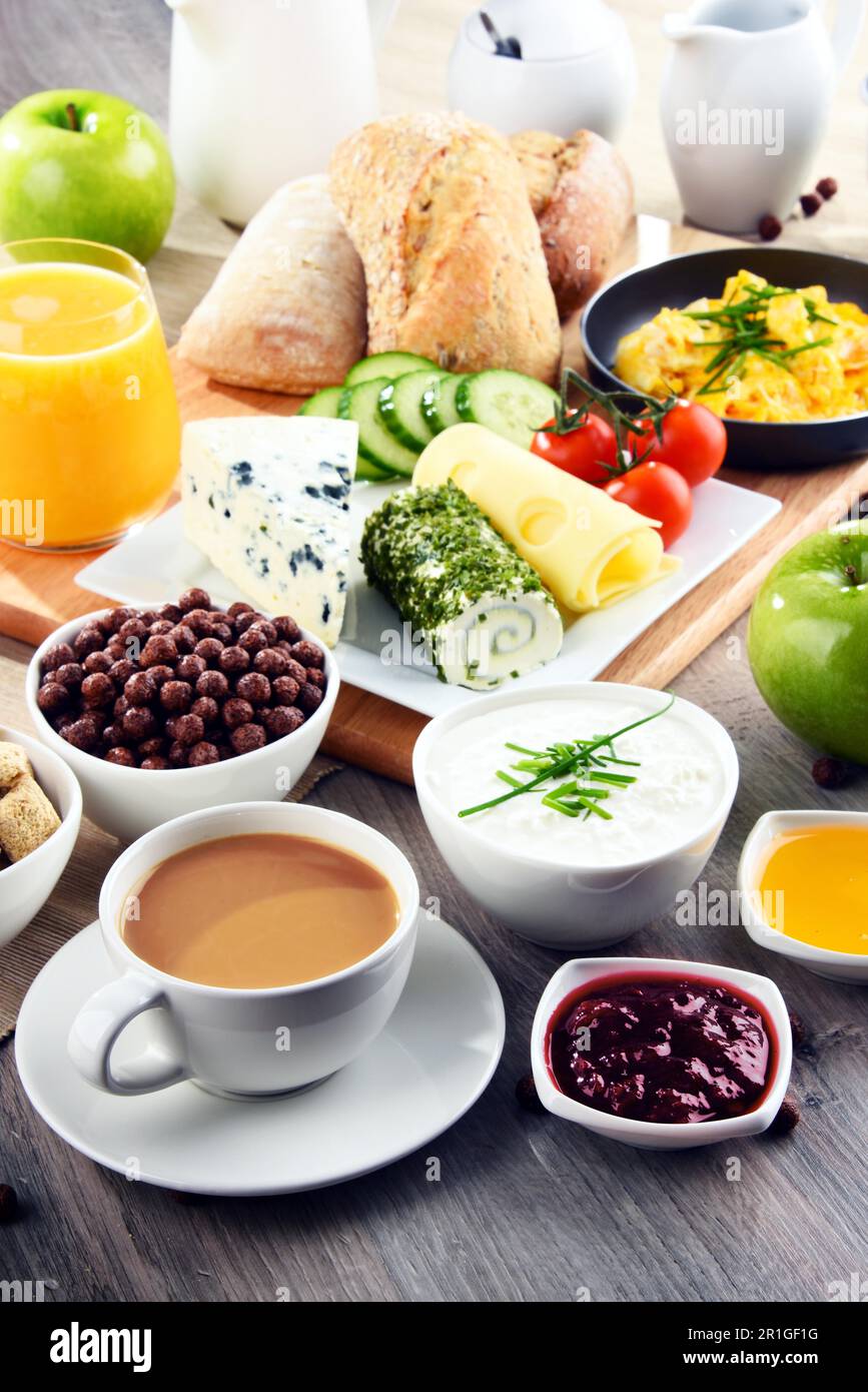 Breakfast served with coffee, orange juice, cheese, cereals and ...