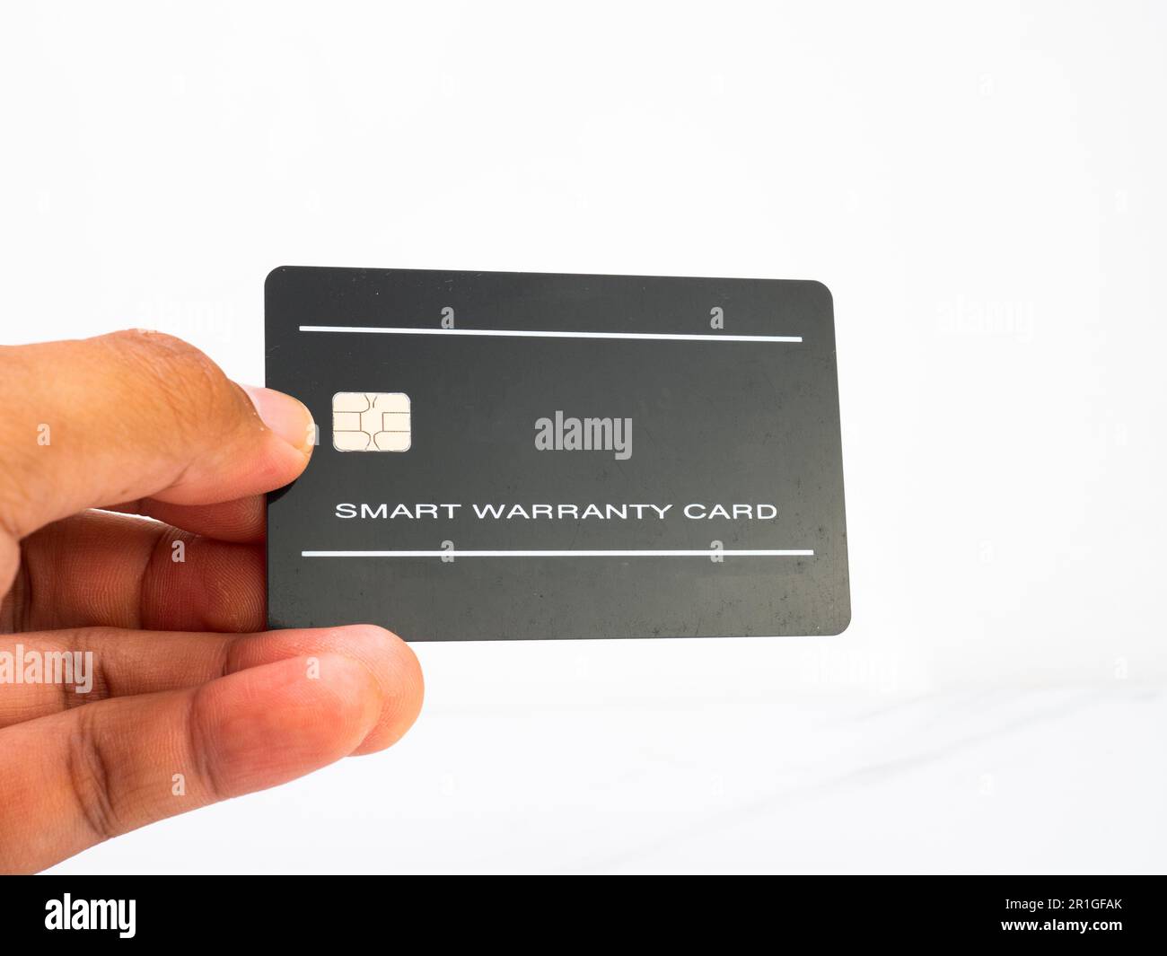 Picture of a black warranty card hold by asian man hand on a white ...