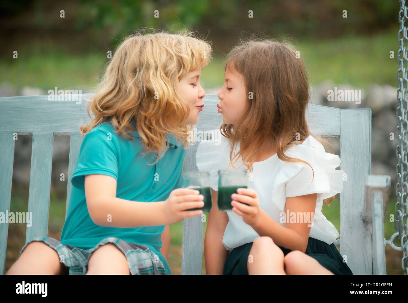Hugging and kissing kids couple. Little lovely children outdoor ...
