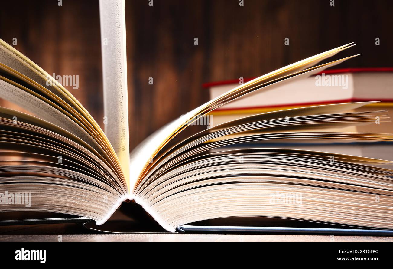 Composition with open book on the table Stock Photo - Alamy