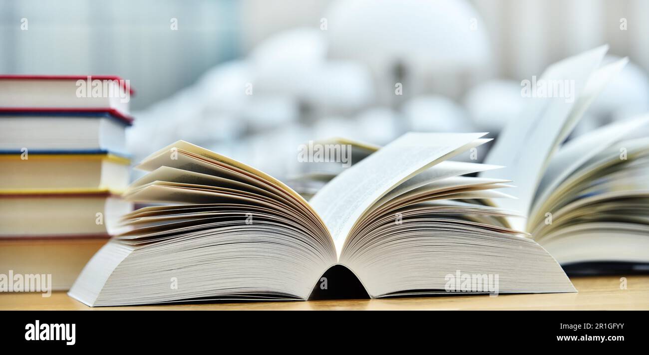 Books lying on the table in the public library Stock Photo - Alamy