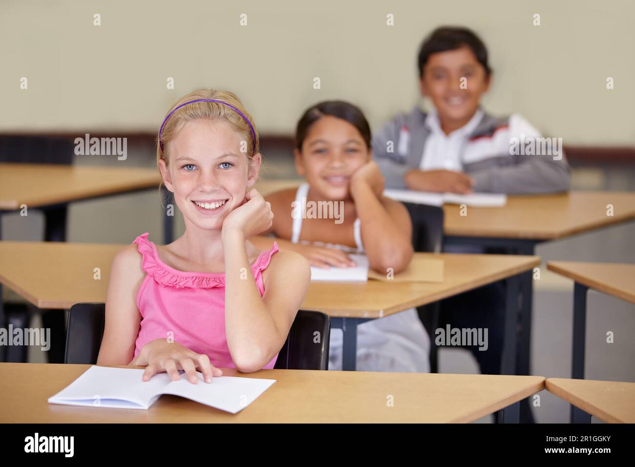 Portrait, kids and smile of student in classroom with book, ready to ...