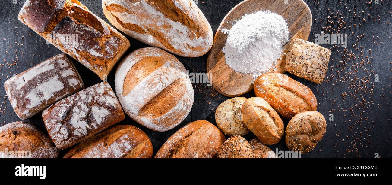 Assorted bakery products including loafs of bread and rolls Stock Photo ...