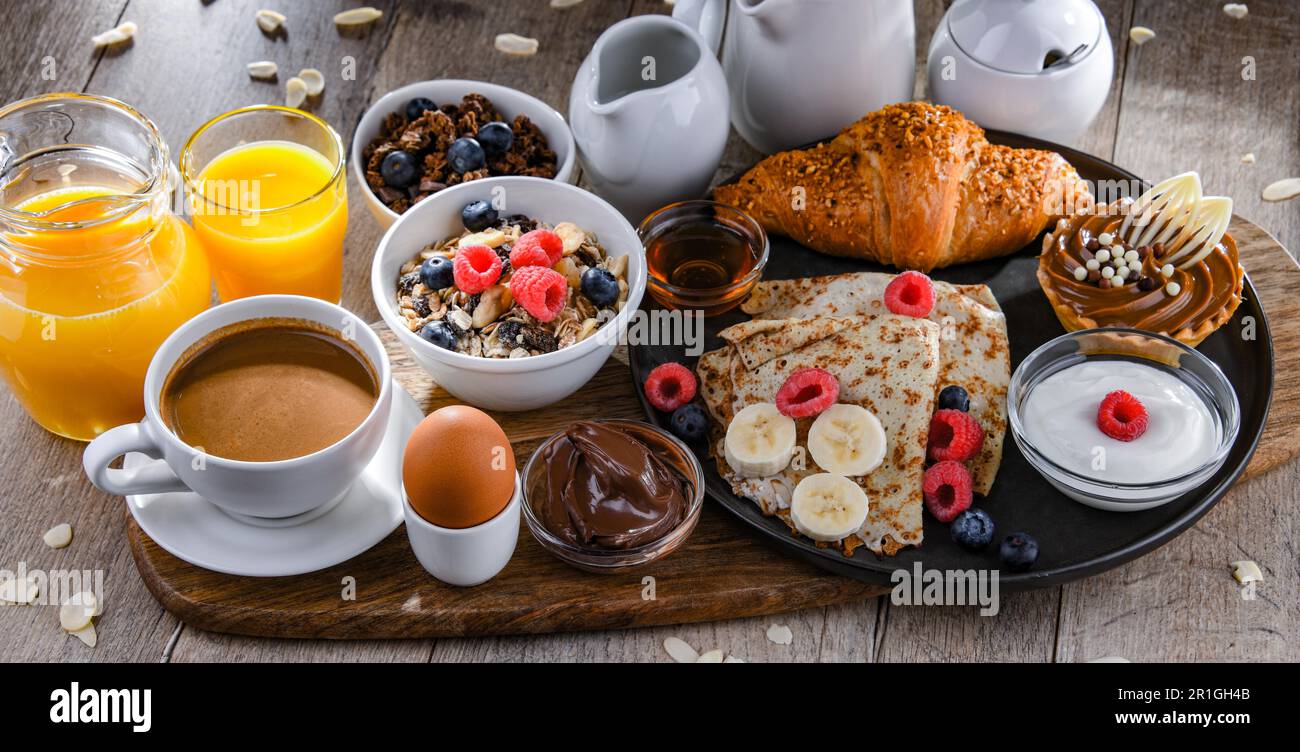 Breakfast served with coffee, orange juice, pancakes, croissants ...