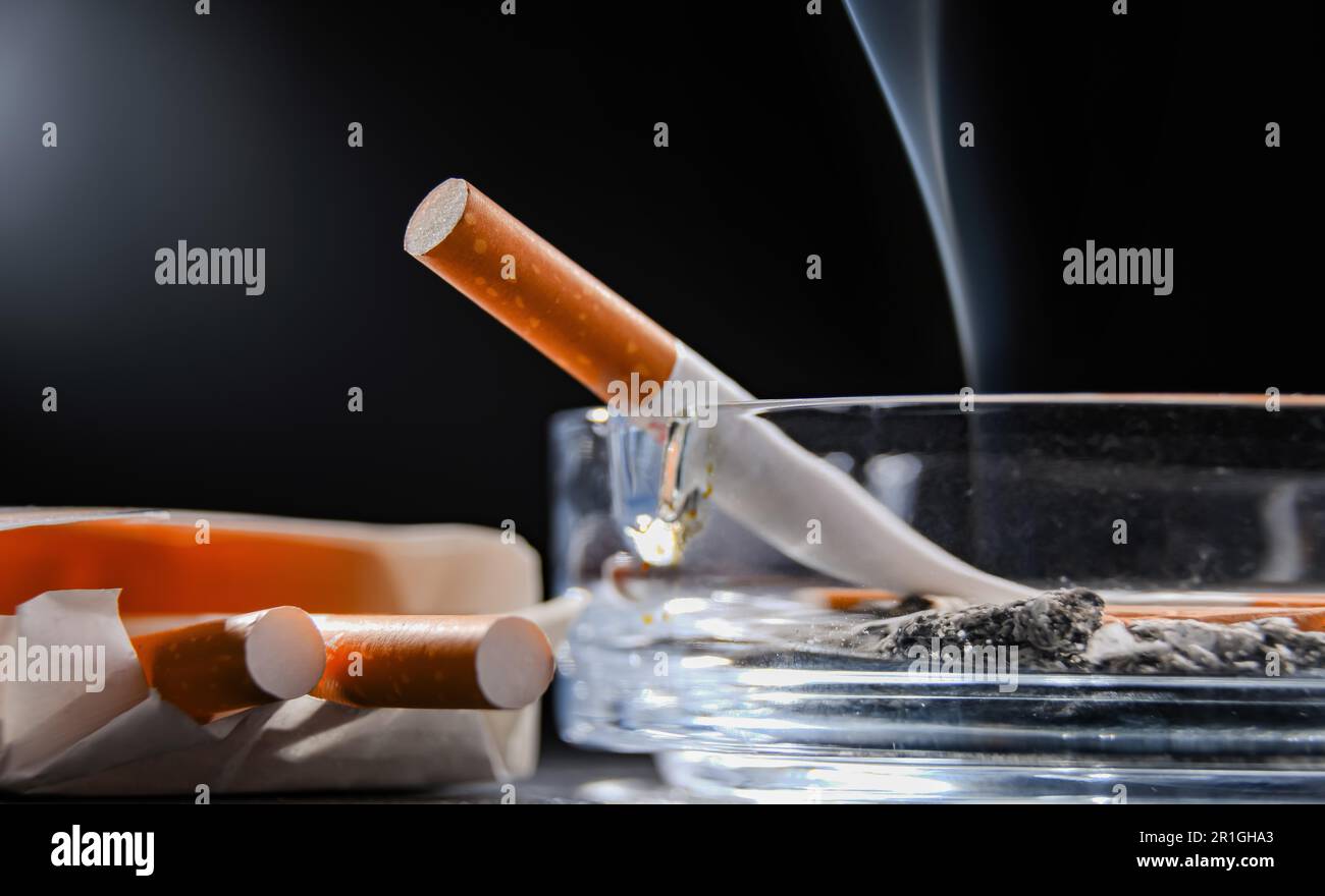 Composition with an ashtray and cigarettes Stock Photo - Alamy