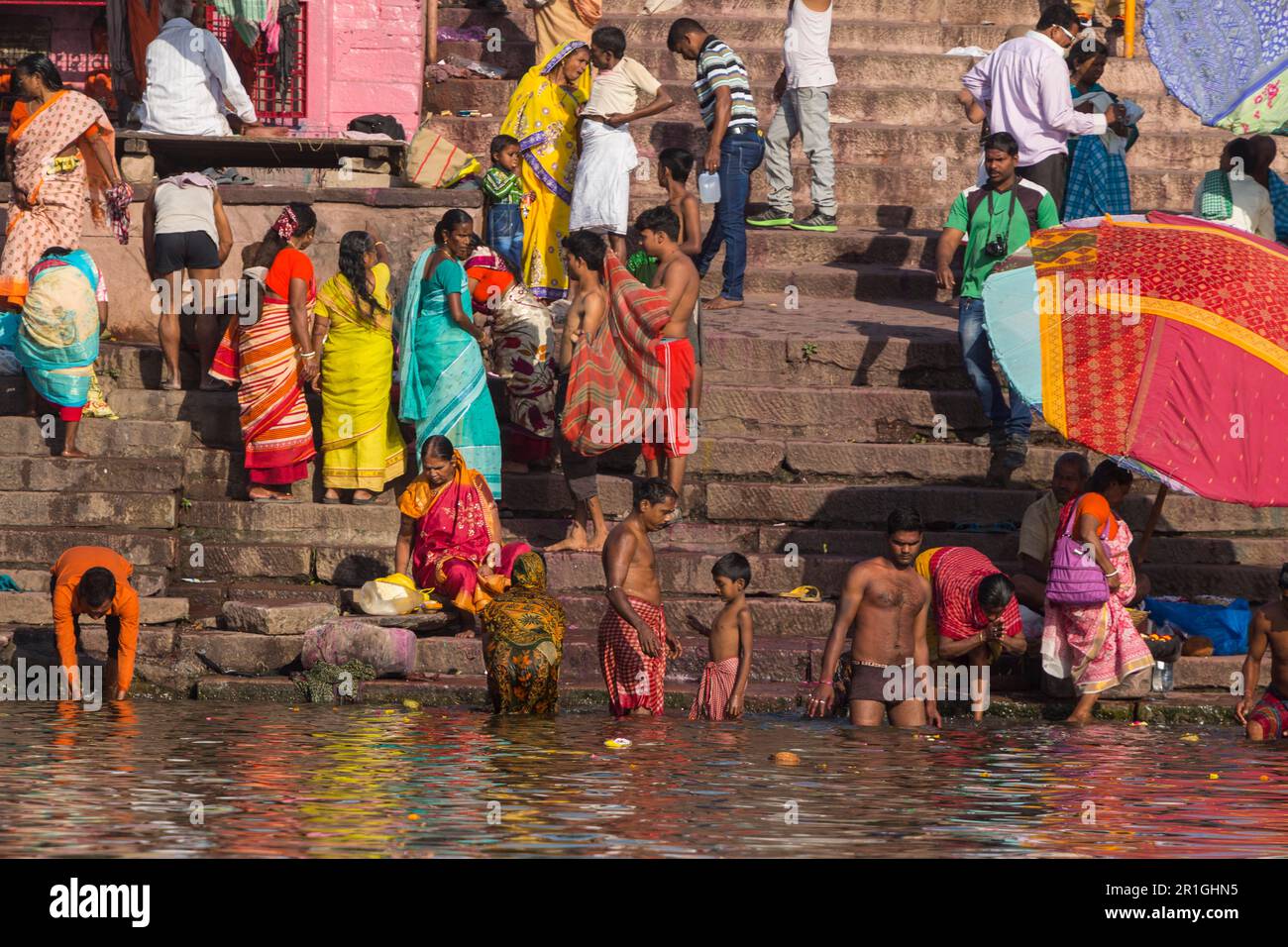 People take an early morning bath in the holy river Ganges, Hindu ...