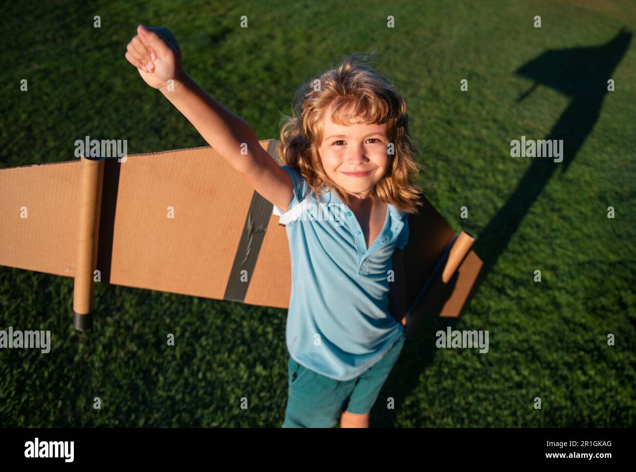 Excited kid superhero with jetpack. Child pilot play on summer day ...