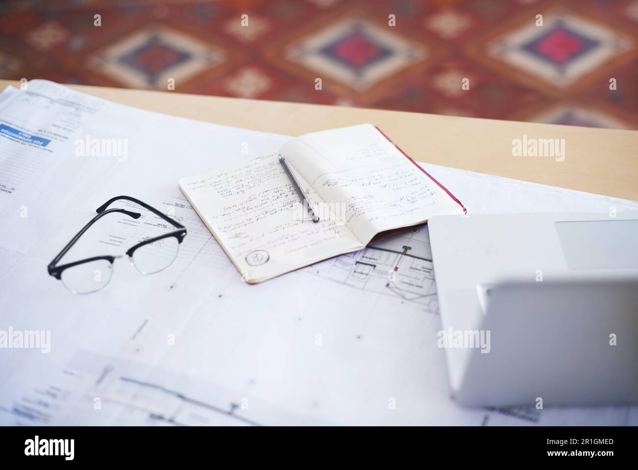 Notebook, laptop and blueprint on desk for architecture planning ...