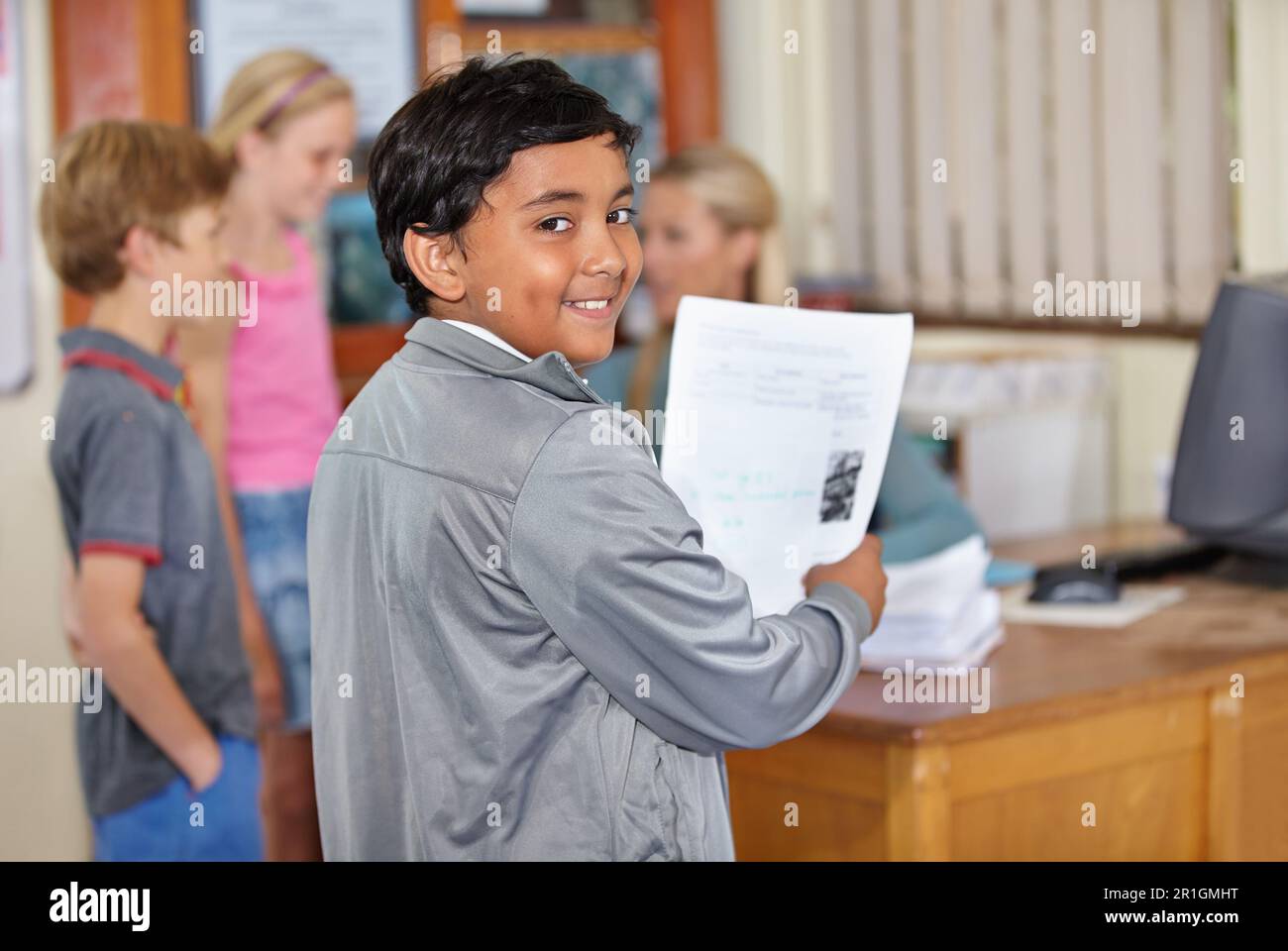 Portrait, child and smile of student with paper in classroom for ...