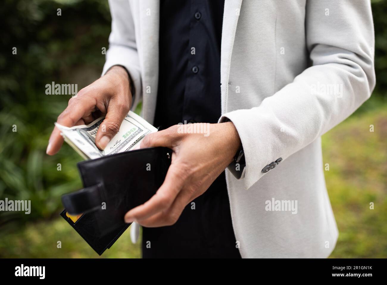 Rich man counting out his money hi-res stock photography and images - Alamy