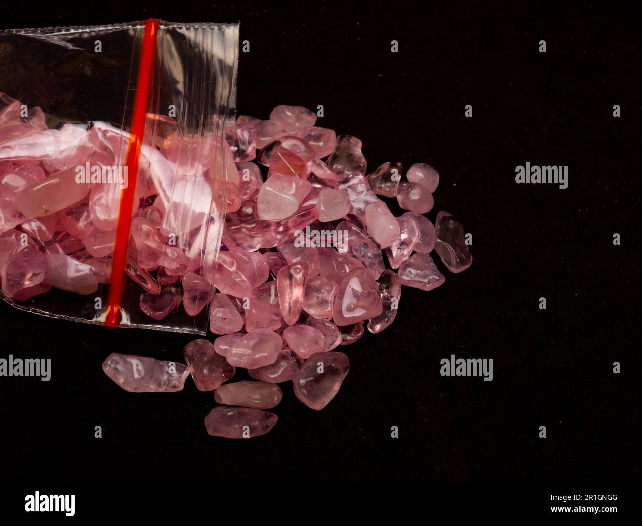 Rough pink colored diamond on black background Stock Photo - Alamy
