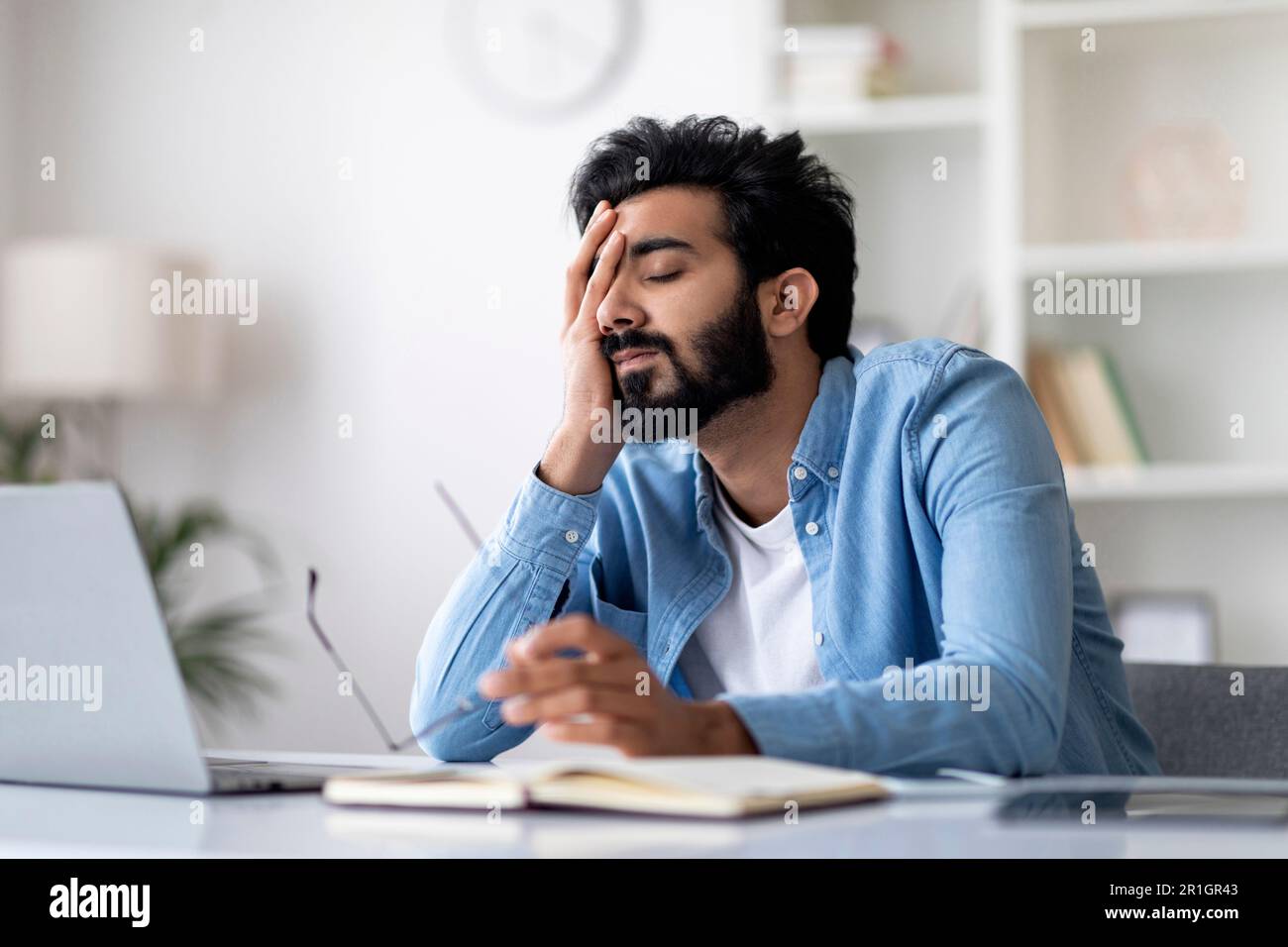 Freelancer Burnout. Tired Indian Man Feeling Sleepy At Workplace In ...