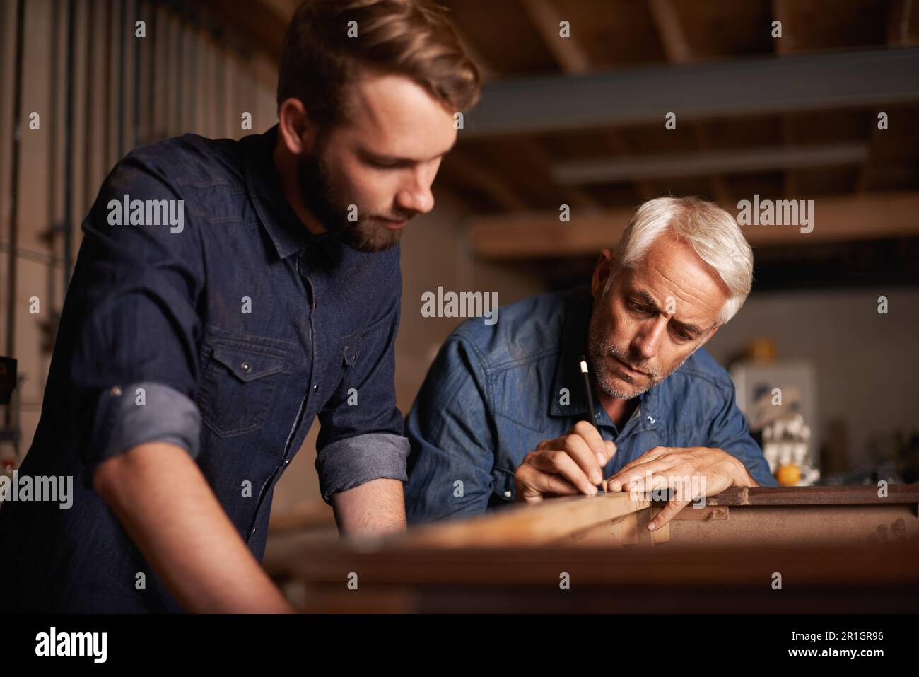 Training, learning and carpentry apprentice with man, teaching woodwork and professional ...