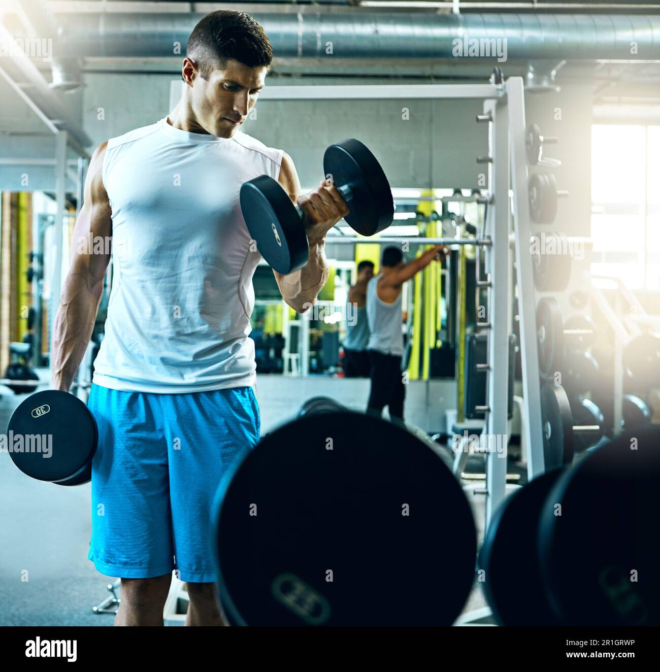 Greatness is earned never awarded. a young man working out alone in the ...