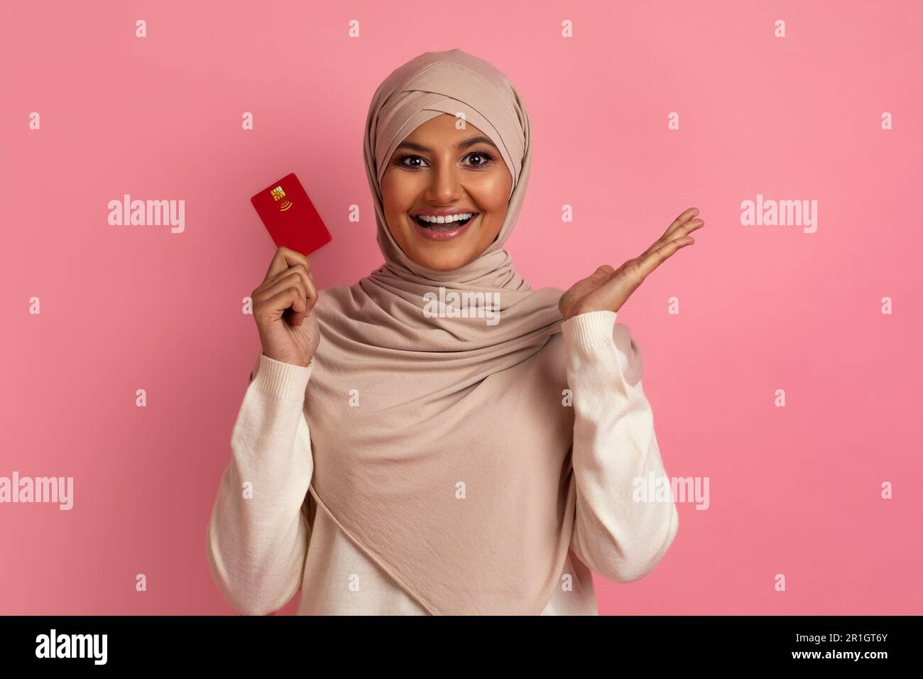 Portrait Of Excited Muslim Woman In Hijab With Credit Card In Hand ...