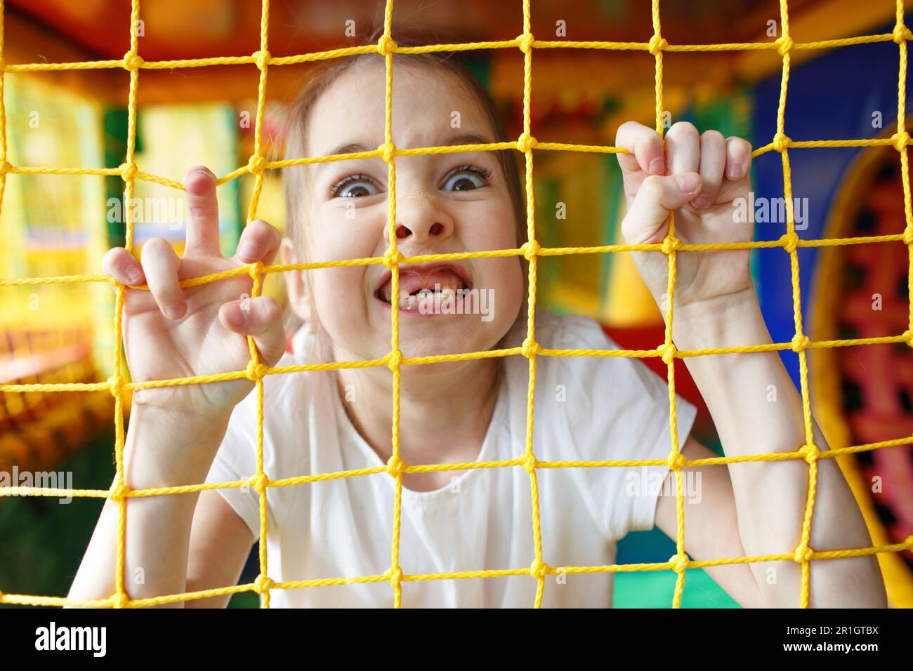 a little girl frolics in a children's play center Stock Photo - Alamy