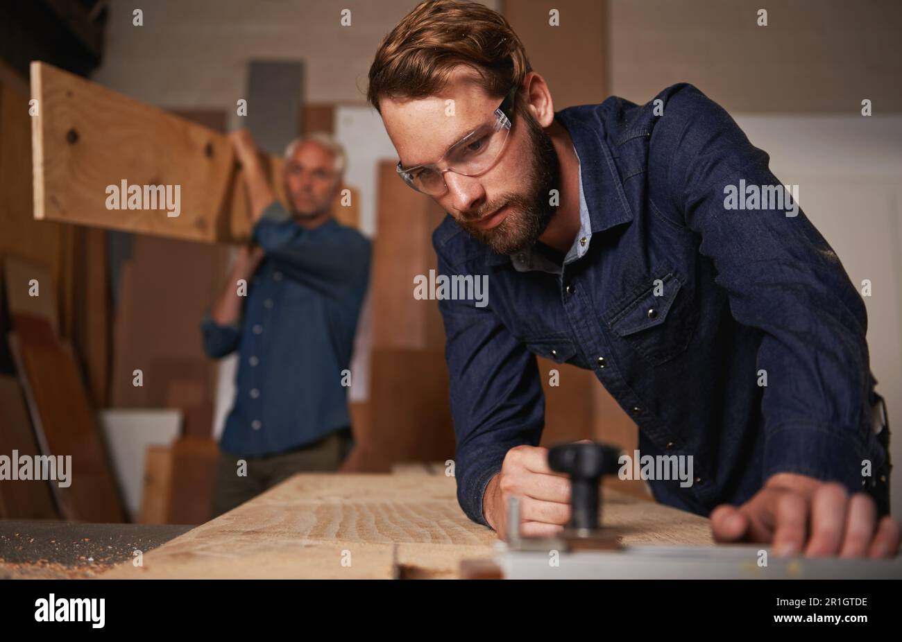 Father son cutting wood hi-res stock photography and images - Alamy