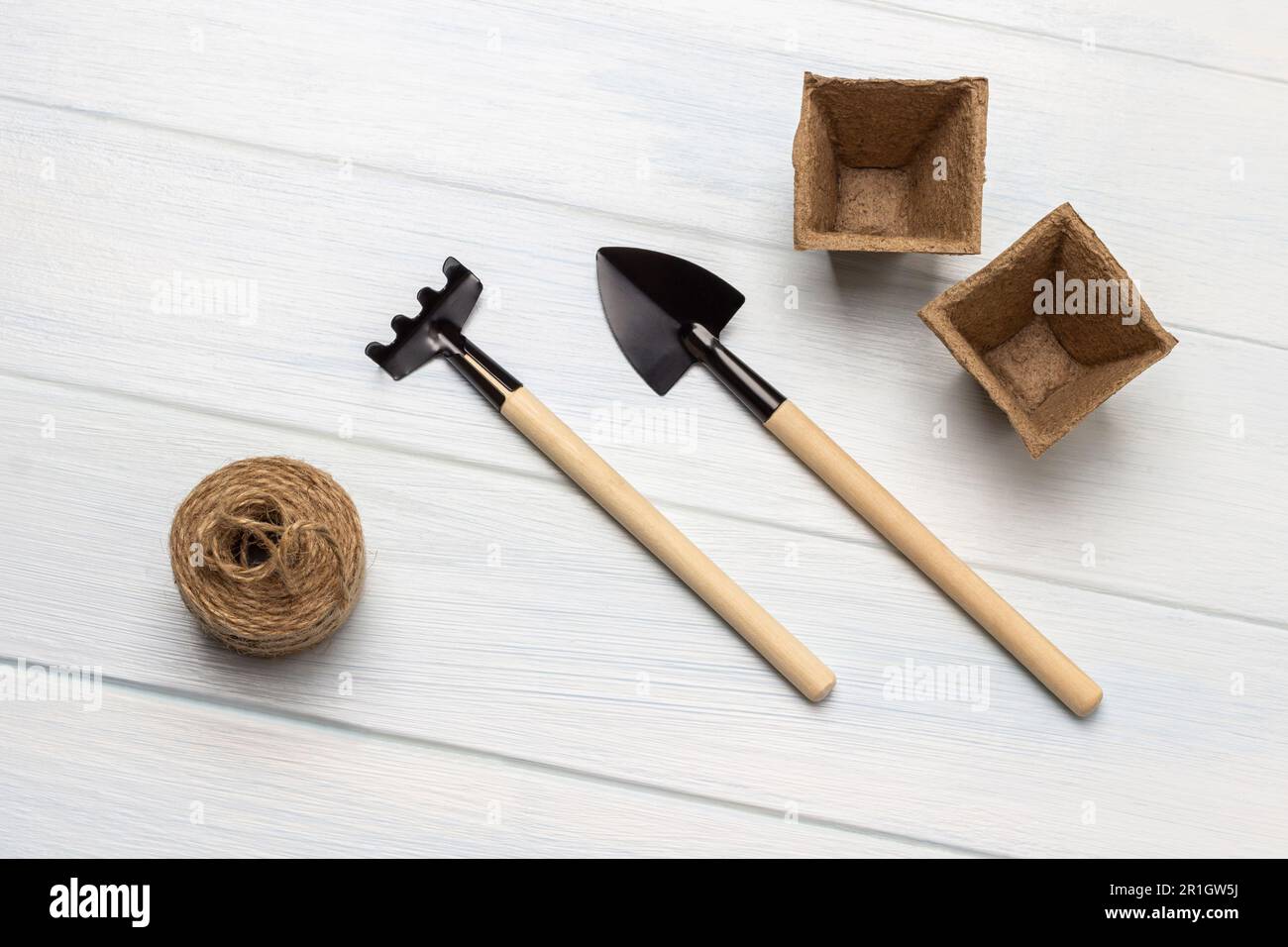 Peat pots and garden tools on a white background. Flat lay Stock Photo ...